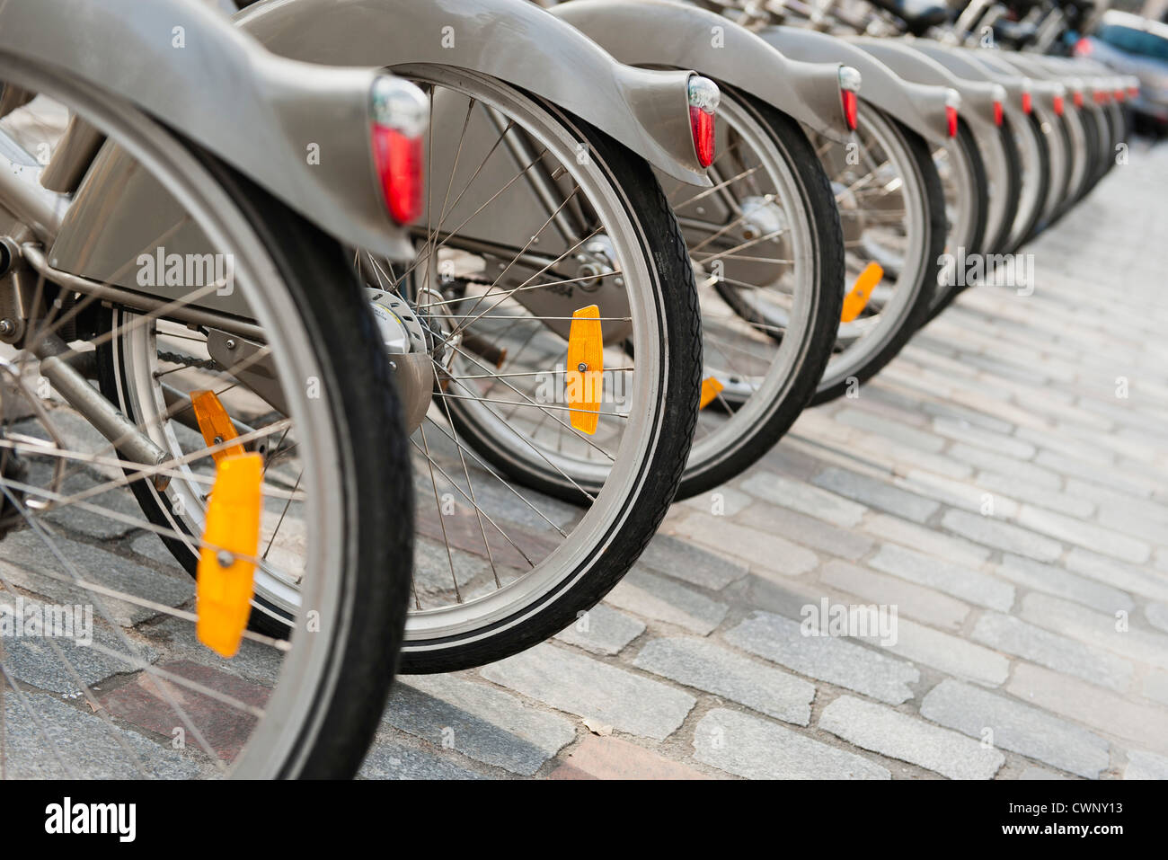 Bicycles parked in a row, cropped Stock Photo - Alamy