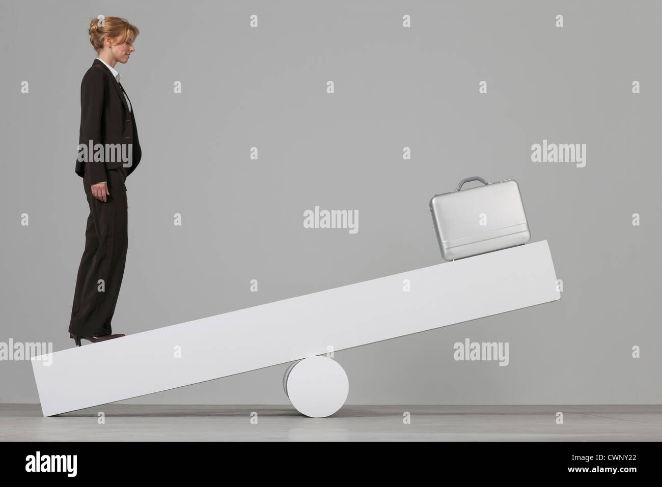 Imbalance seesaw hi-res stock photography and images - Alamy