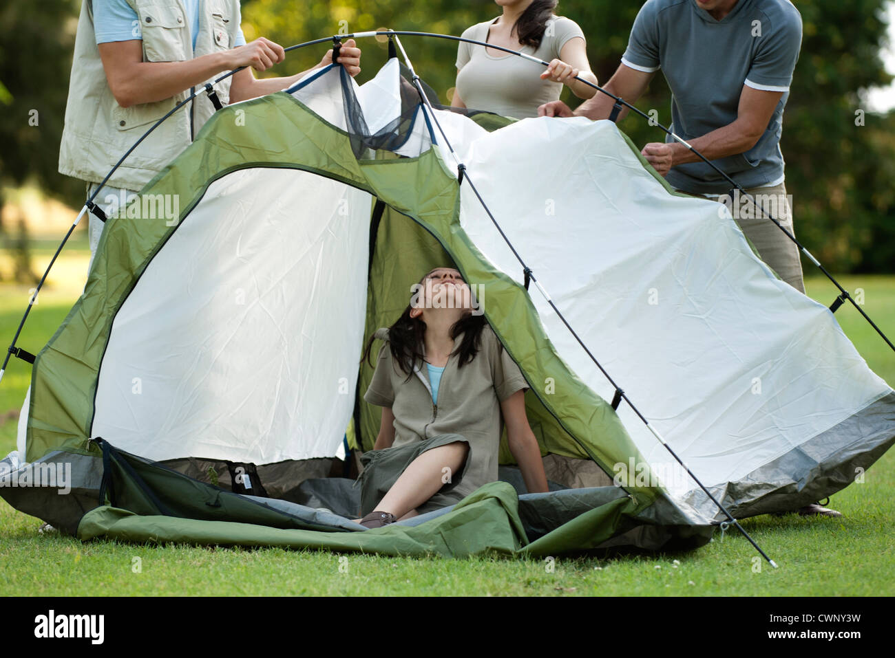 Campers setting up tent Stock Photo - Alamy