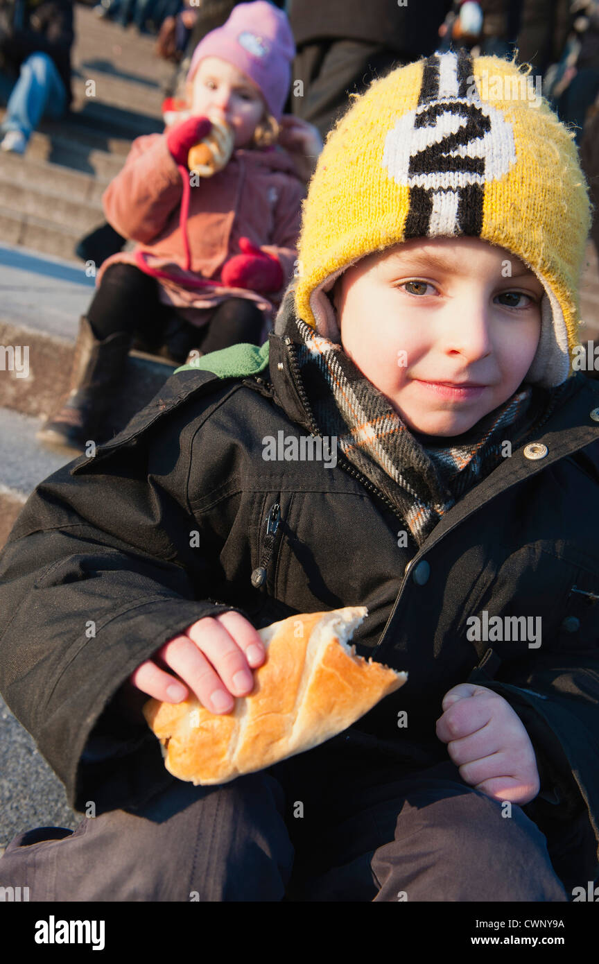 Boy eating pastry outdoors, portrait Stock Photo - Alamy