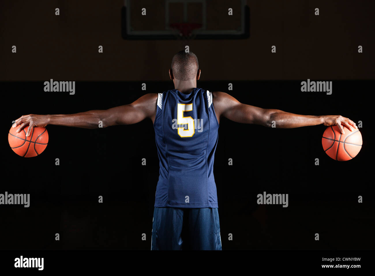 Rear view young man holding basketball hi-res stock photography and ...