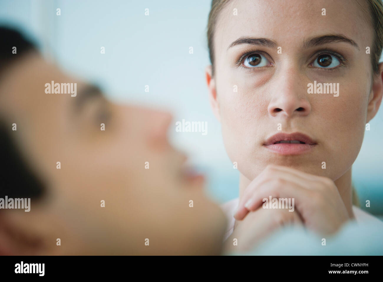 Woman praying, sick man in foreground Stock Photo - Alamy