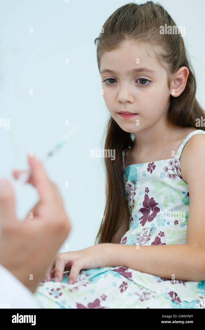 Little girl anxiously awaiting vaccination Stock Photo - Alamy