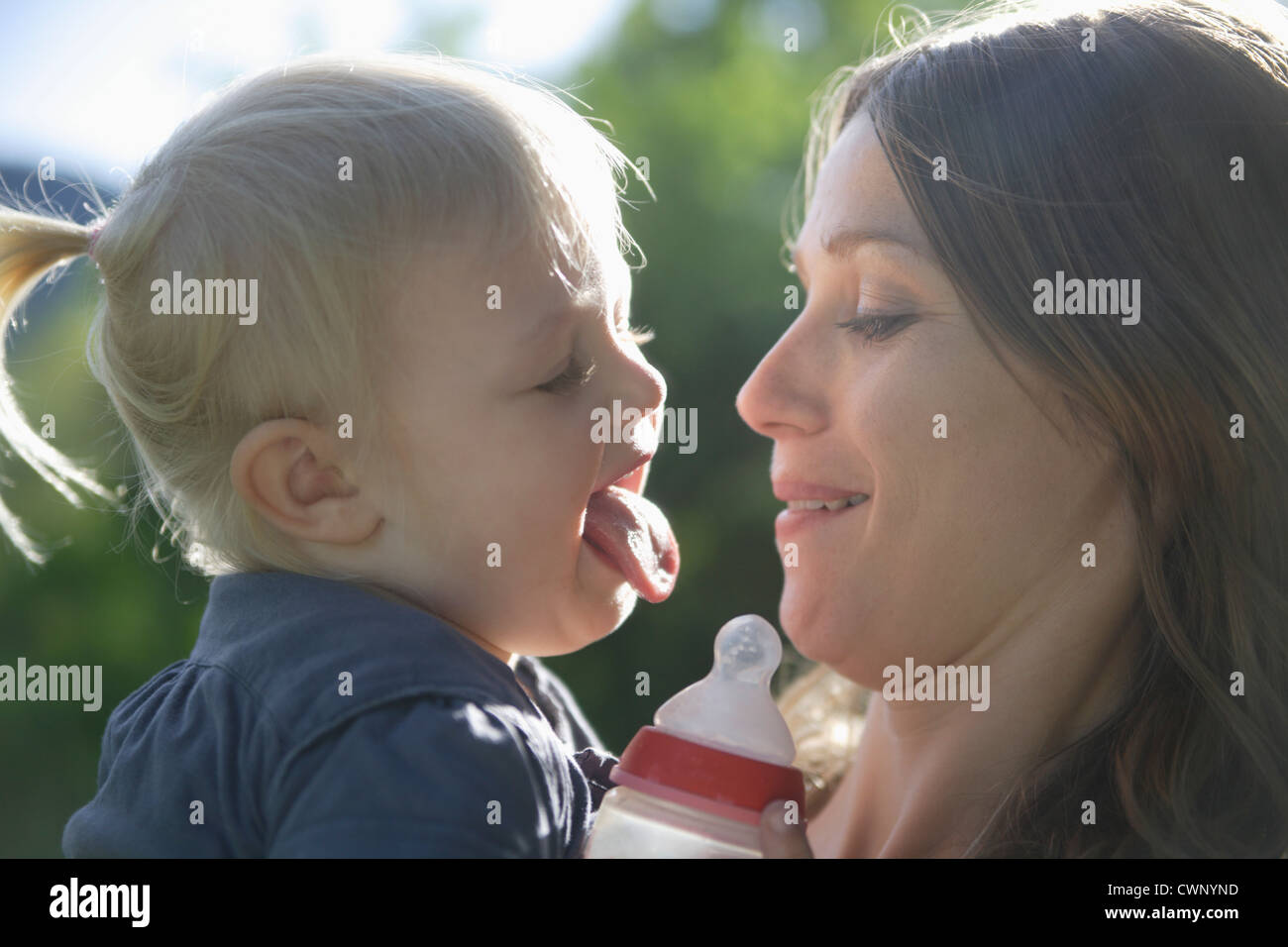 Germany, Bavaria, Mother and daughter with baby bottle Stock Photo - Alamy