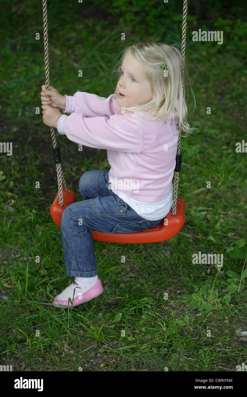 Germany, Bavaria, Girl playing on swing Stock Photo - Alamy