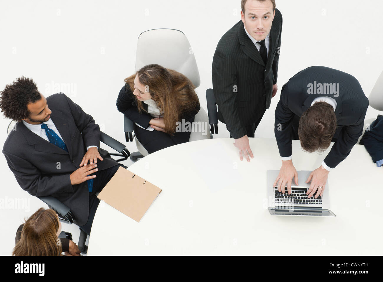Businessman working with associates at meeting Stock Photo - Alamy