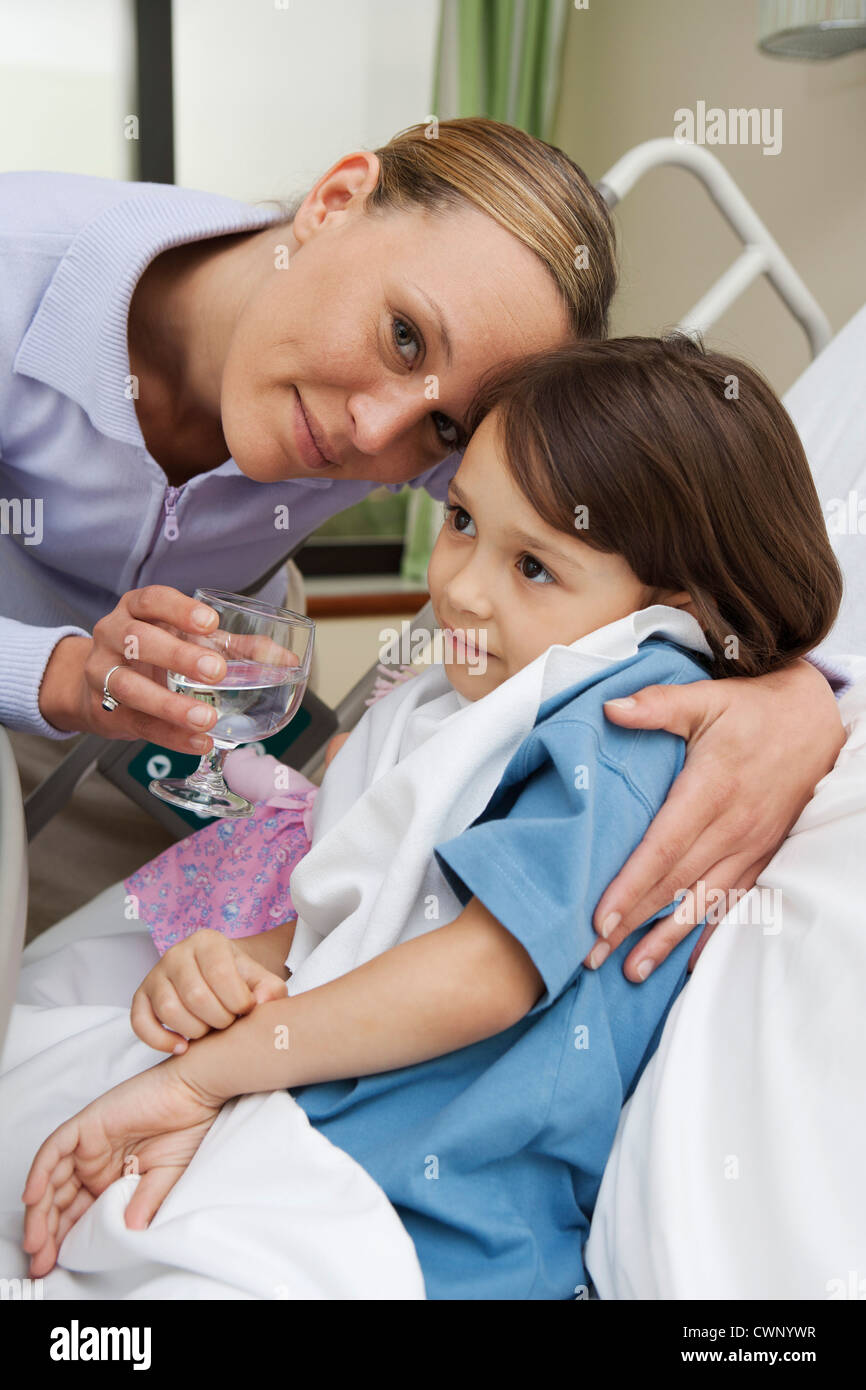 Mother comforting sick daughter in hospital bed Stock Photo - Alamy