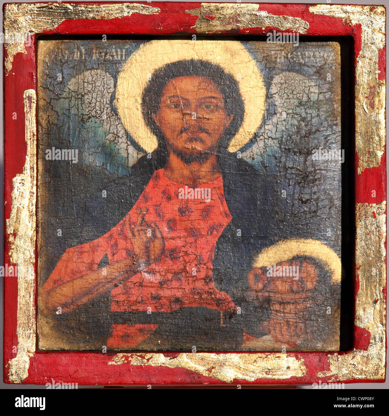 An icon shows an Eastern Orthodox saint. A wooden perfume carrier, from ...