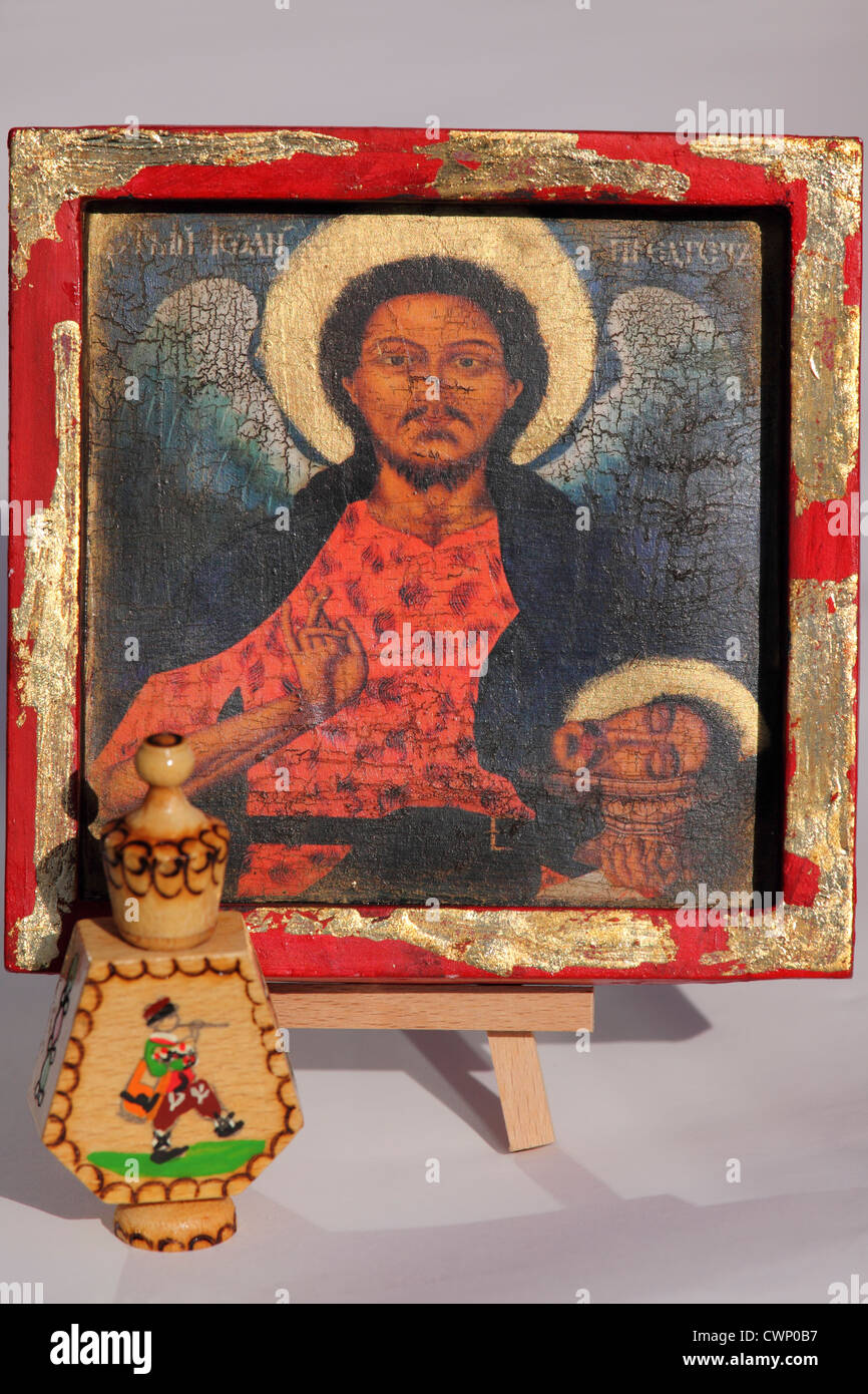 An icon shows an Eastern Orthodox saint. A wooden perfume carrier, from ...