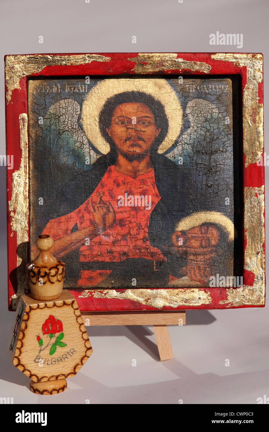 An icon shows an Eastern Orthodox saint. A wooden perfume carrier, from ...