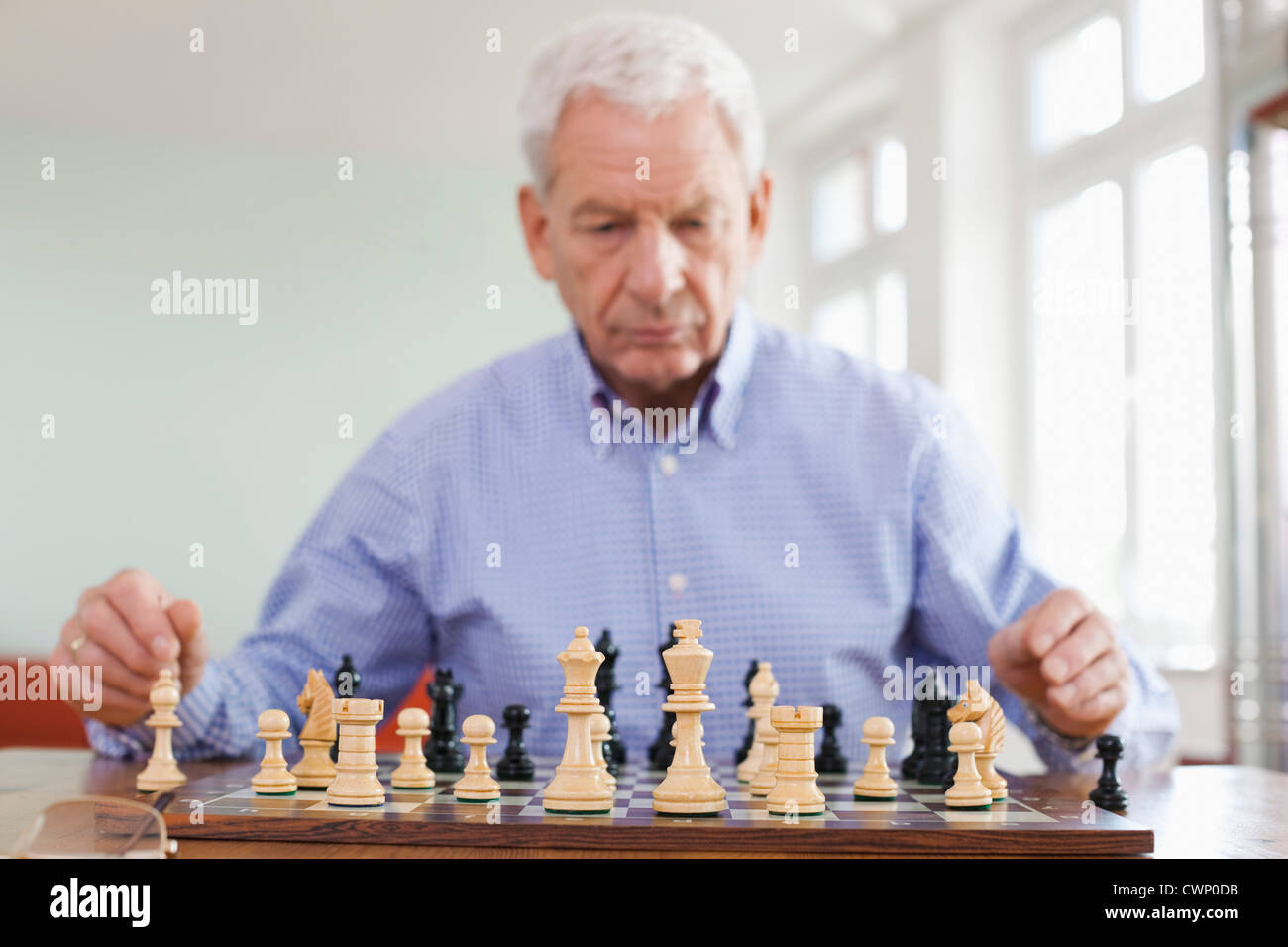 Germany, Leipzig, Senior man playing chess game Stock Photo - Alamy