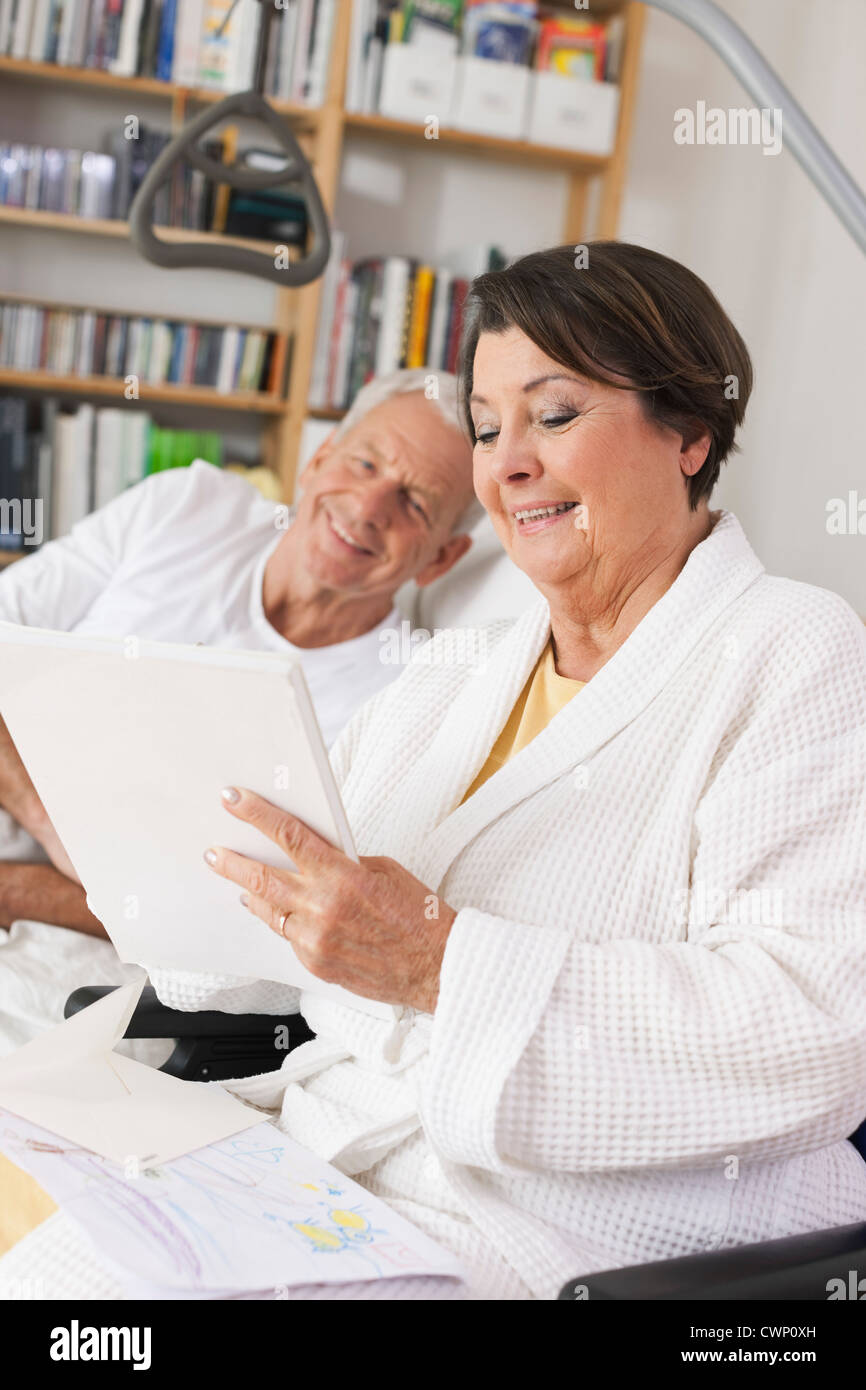 Germany, Leipzig, Senior man and woman reading paper Stock Photo - Alamy