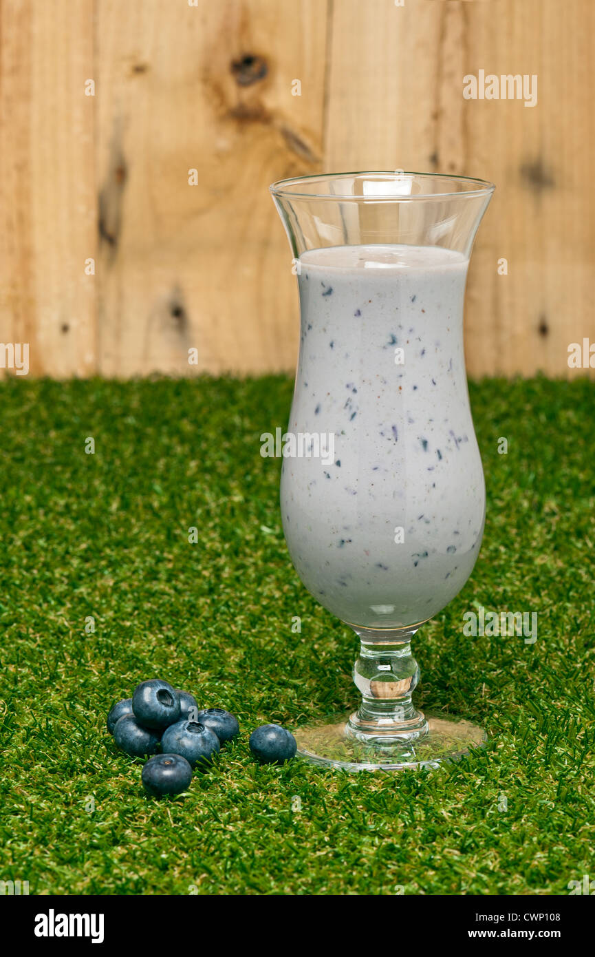 Blueberry milk shake with real fruit and a wooden wall Stock Photo - Alamy