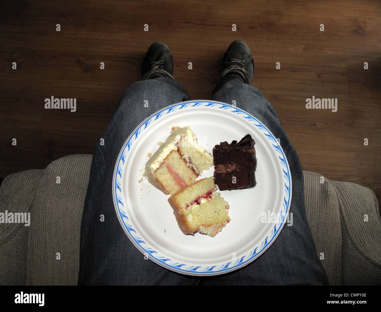 Plate of cake slices on man's lap, directly above Stock Photo - Alamy