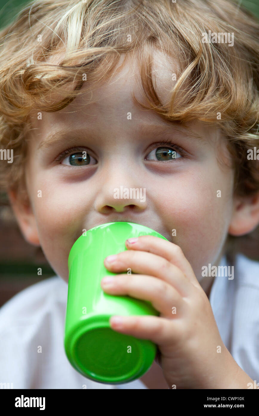 Little boy drinking from cup, portrait Stock Photo - Alamy