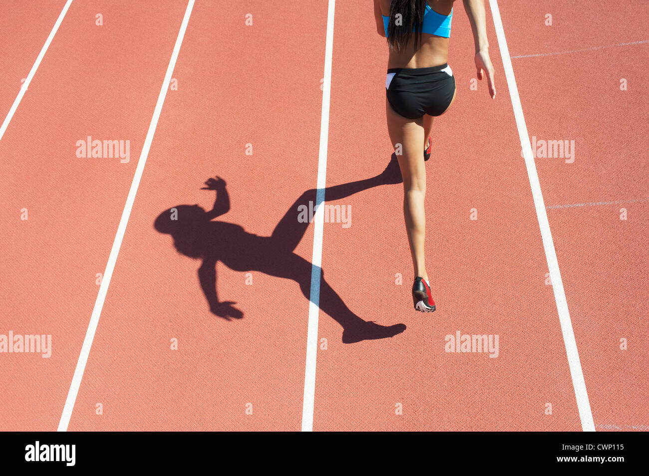 Female athlete running on track, rear view Stock Photo - Alamy