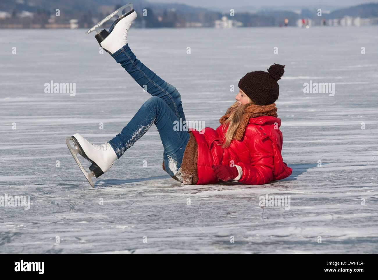 Austria, Teenage girl fallen on ice rink while skating Stock Photo - Alamy