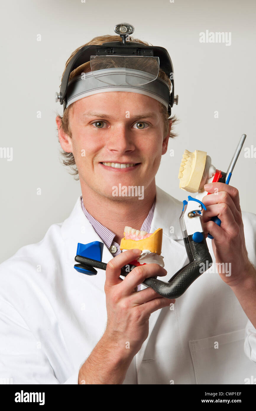 Dentist holding dentures in articulator, portrait Stock Photo - Alamy