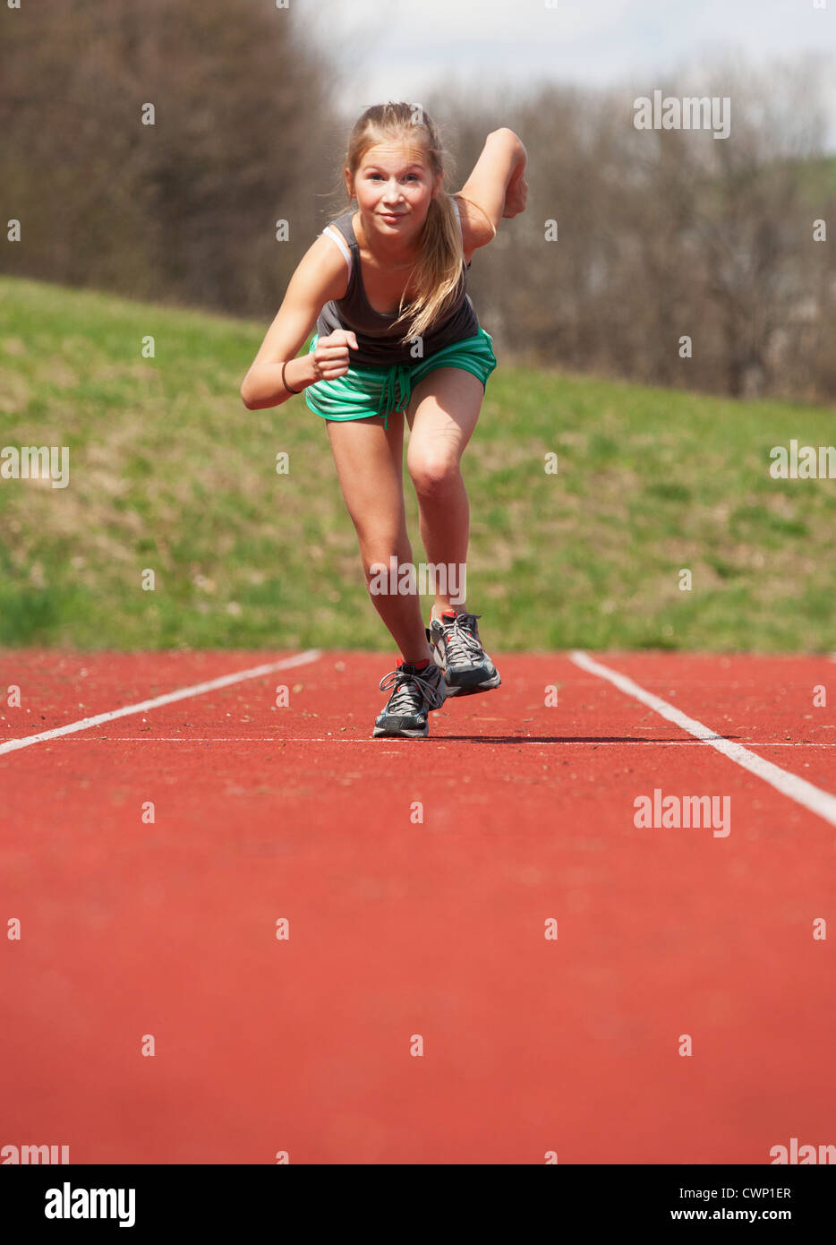 Austria, Teenage girl running on track, portrait Stock Photo - Alamy