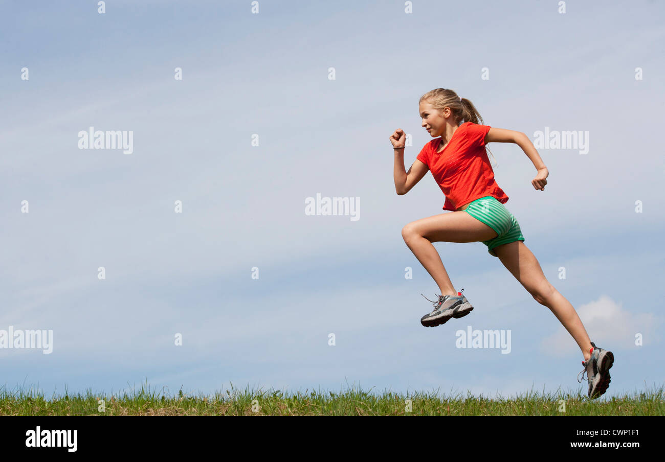 Austria, Teenage girl running on grass Stock Photo - Alamy
