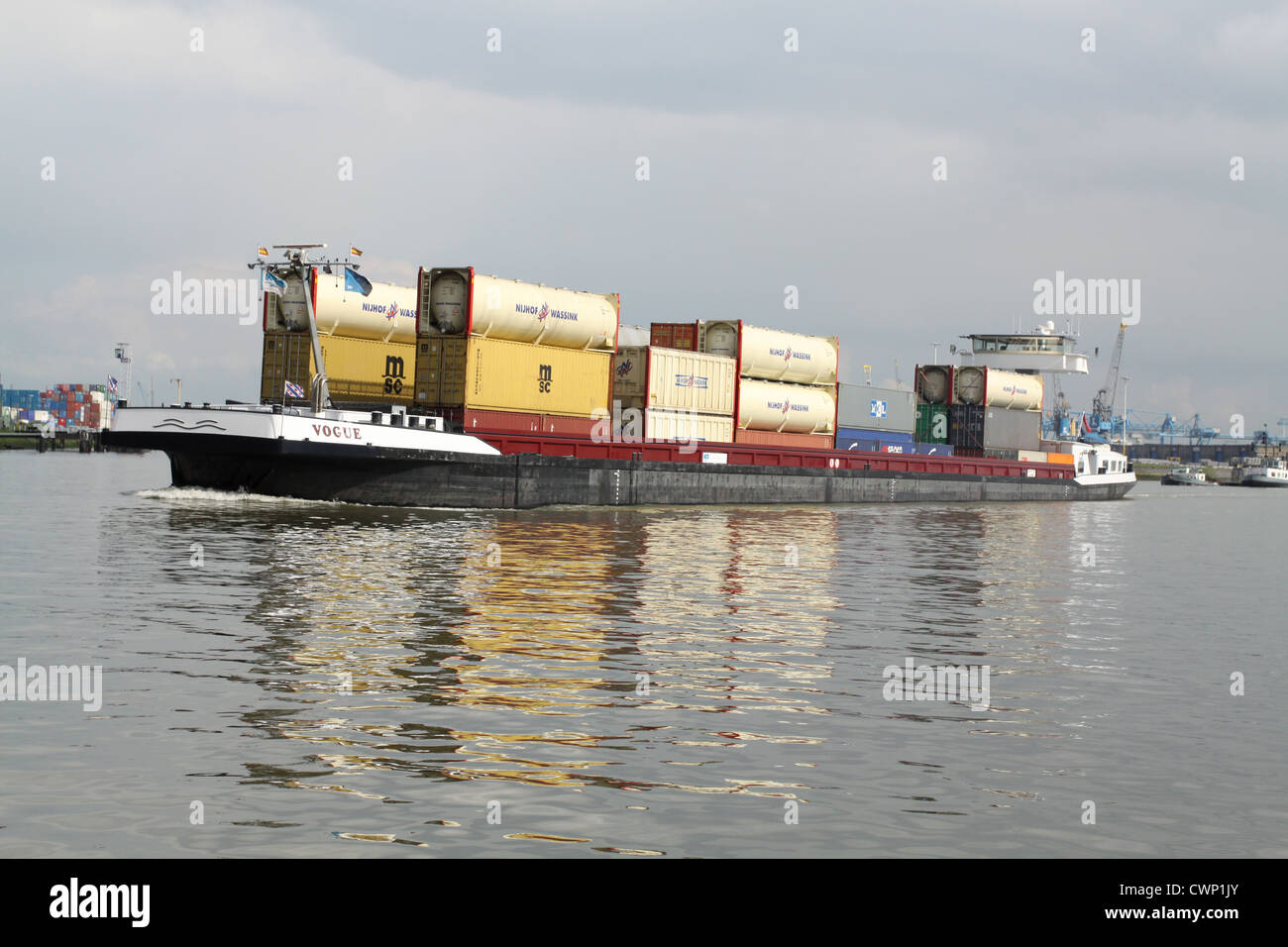 Inland waterway barge Vogue transits the port of Rotterdam carrying ...