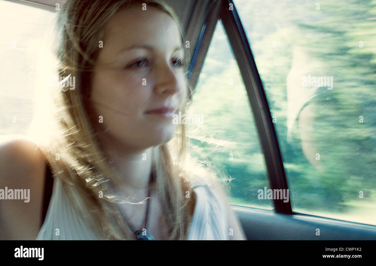 Woman riding in car, defocused Stock Photo - Alamy
