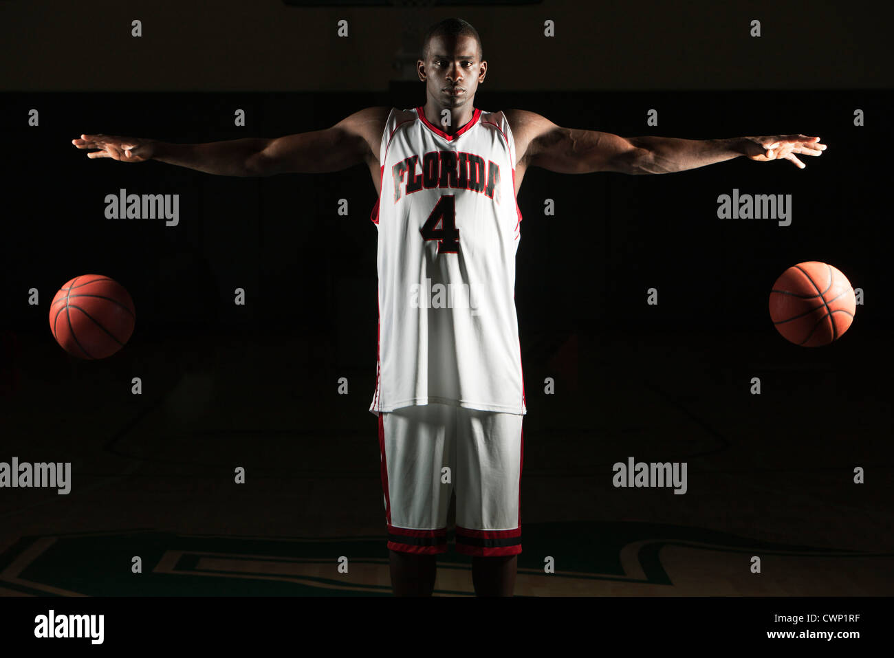 Basketball player dribbling two balls Stock Photo - Alamy