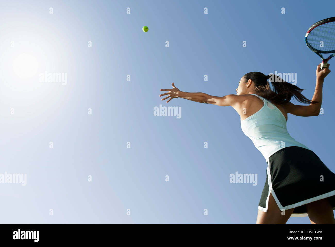 Female tennis player serving ball, low angle view Stock Photo - Alamy