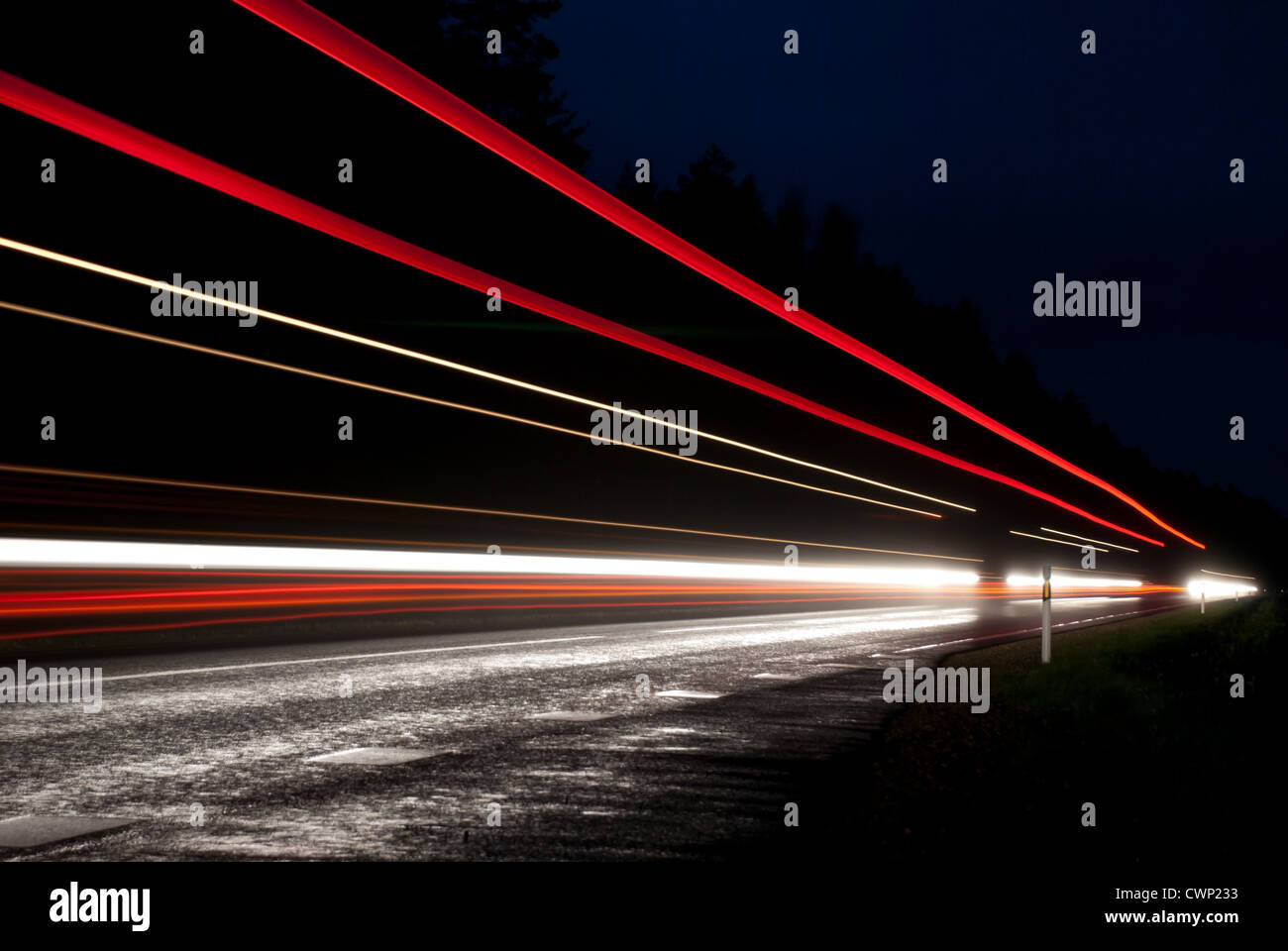 Long exposure shot - white and red light trails created by passing cars ...