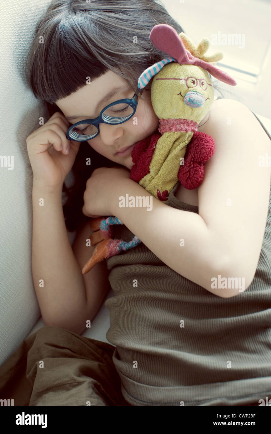 Girl napping with stuffed toy Stock Photo - Alamy