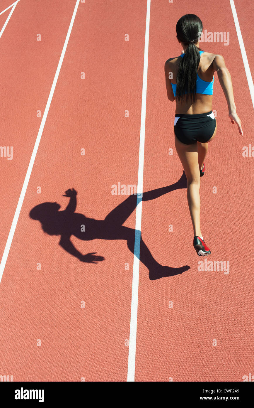 Female athlete running on track, rear view Stock Photo - Alamy