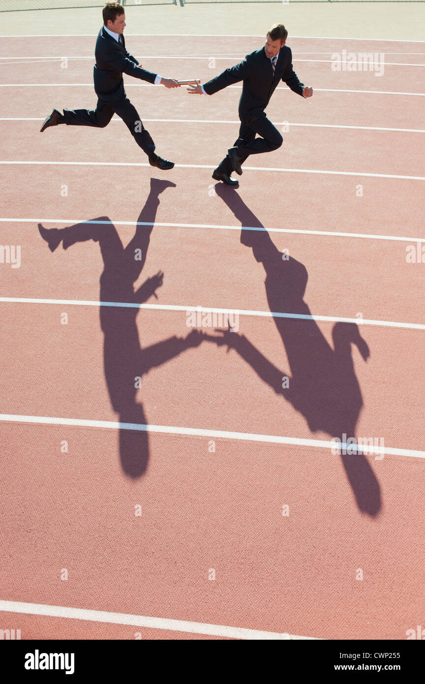 Businessmen running relay race Stock Photo - Alamy