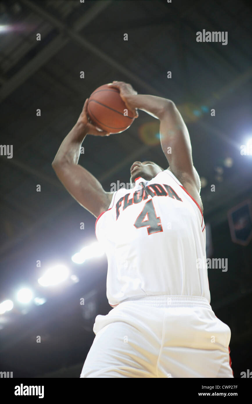 Basketball player jumping with basketball, low angle view Stock Photo ...