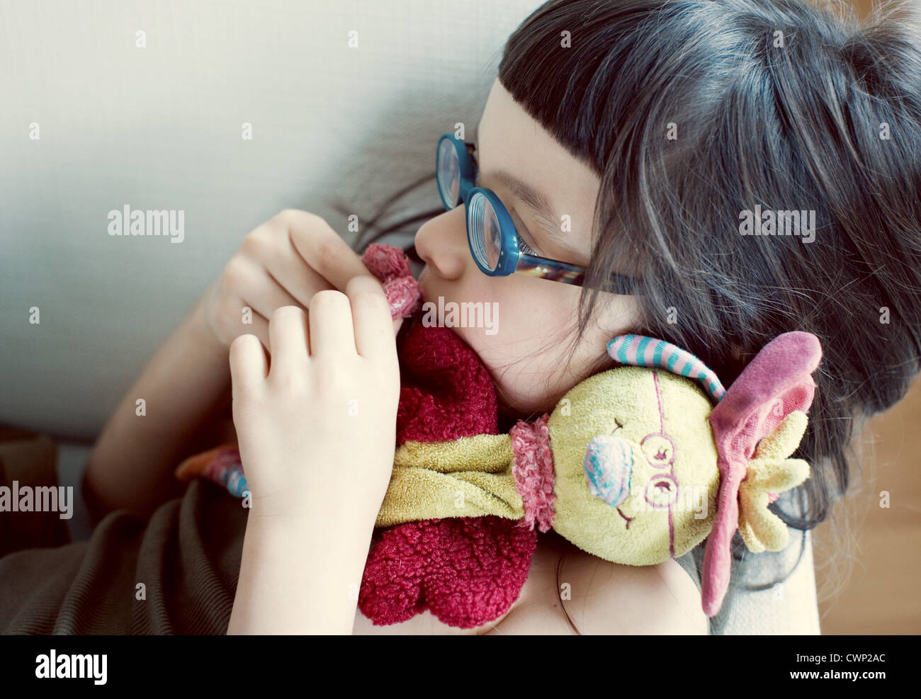 Girl cuddling stuffed toy Stock Photo - Alamy