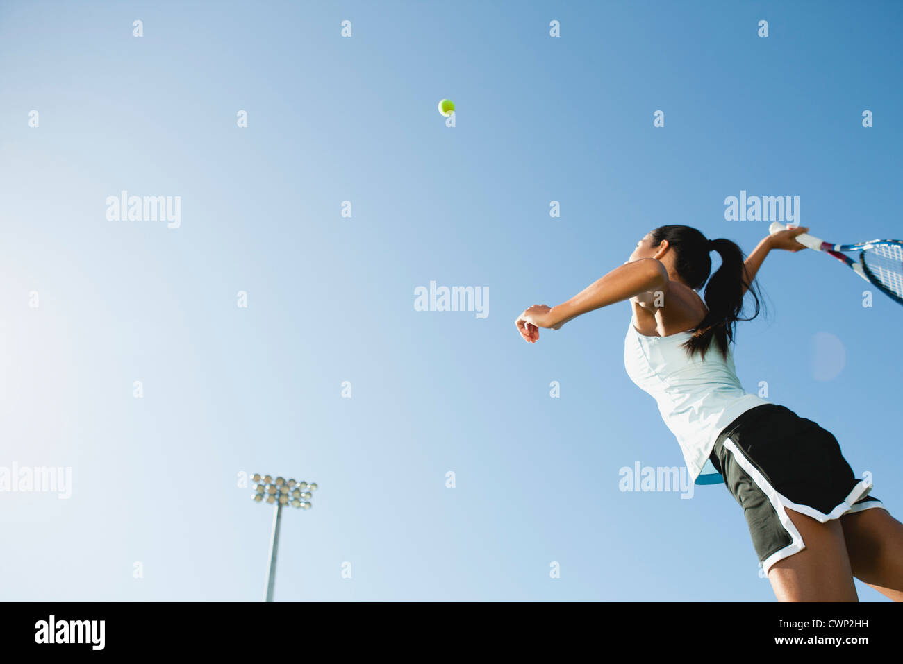 Female tennis player serving ball, low angle view Stock Photo - Alamy