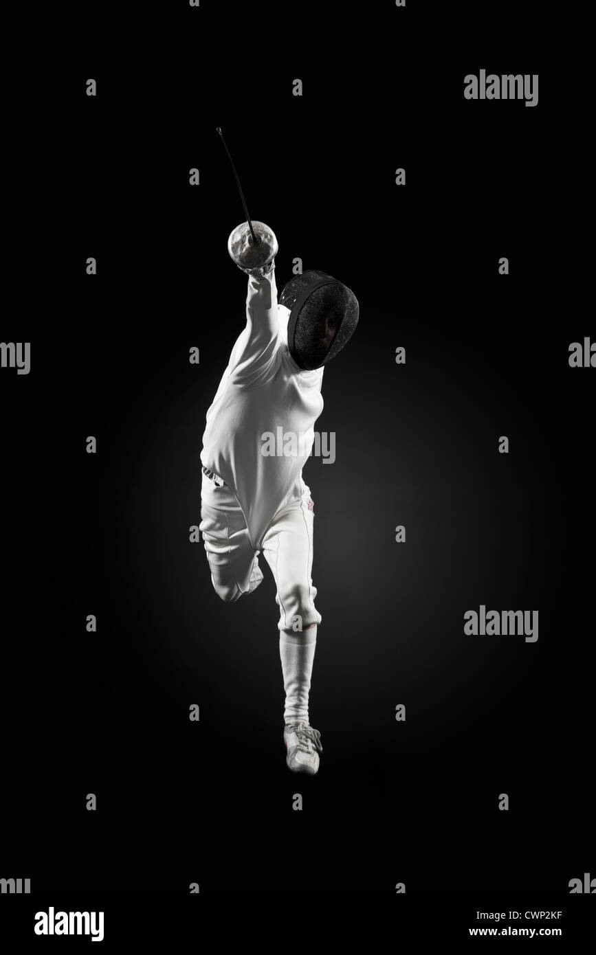 Fencer attacking in air, portrait Stock Photo - Alamy
