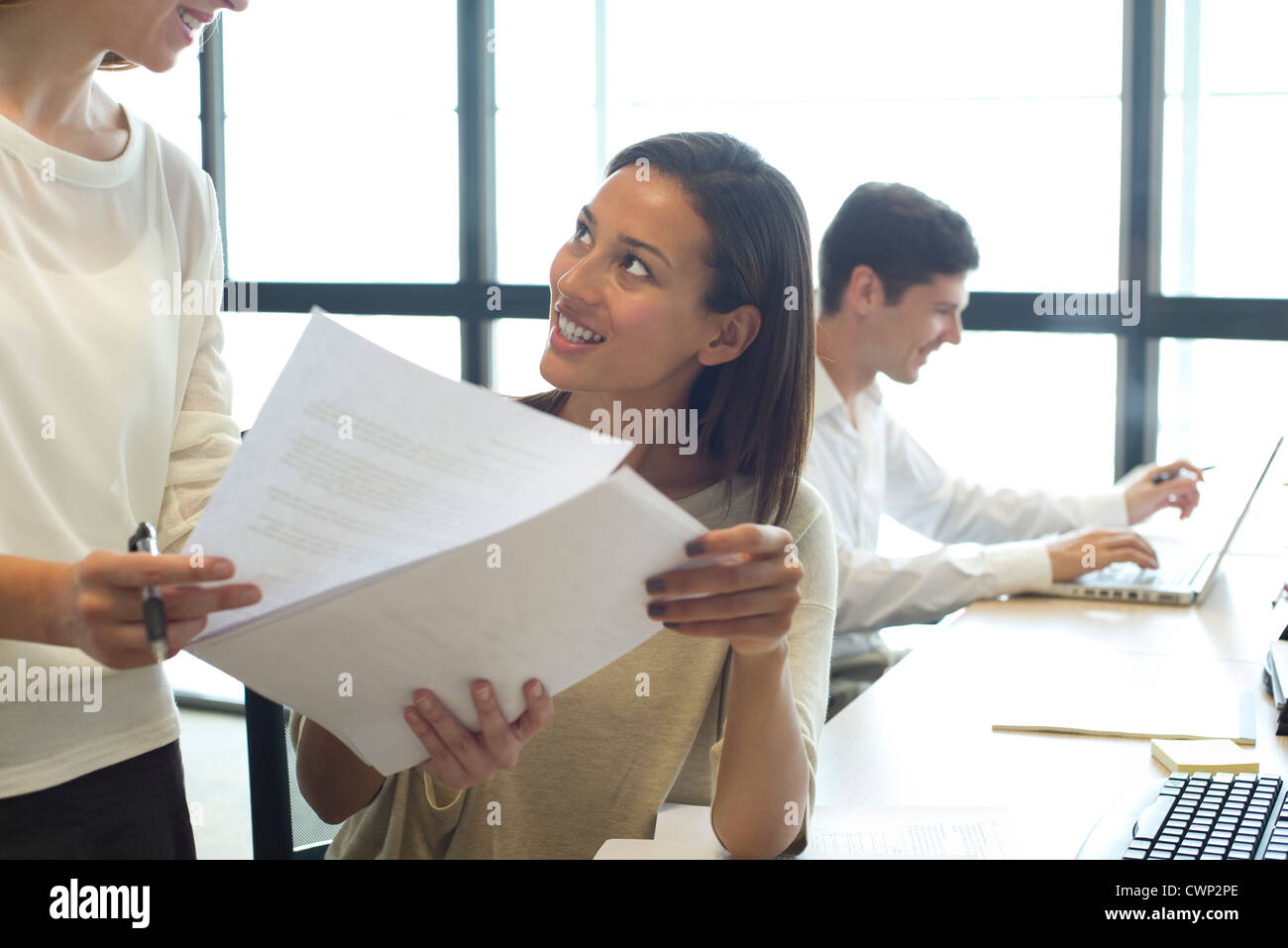 Three professional women reviewing documents hi-res stock photography ...