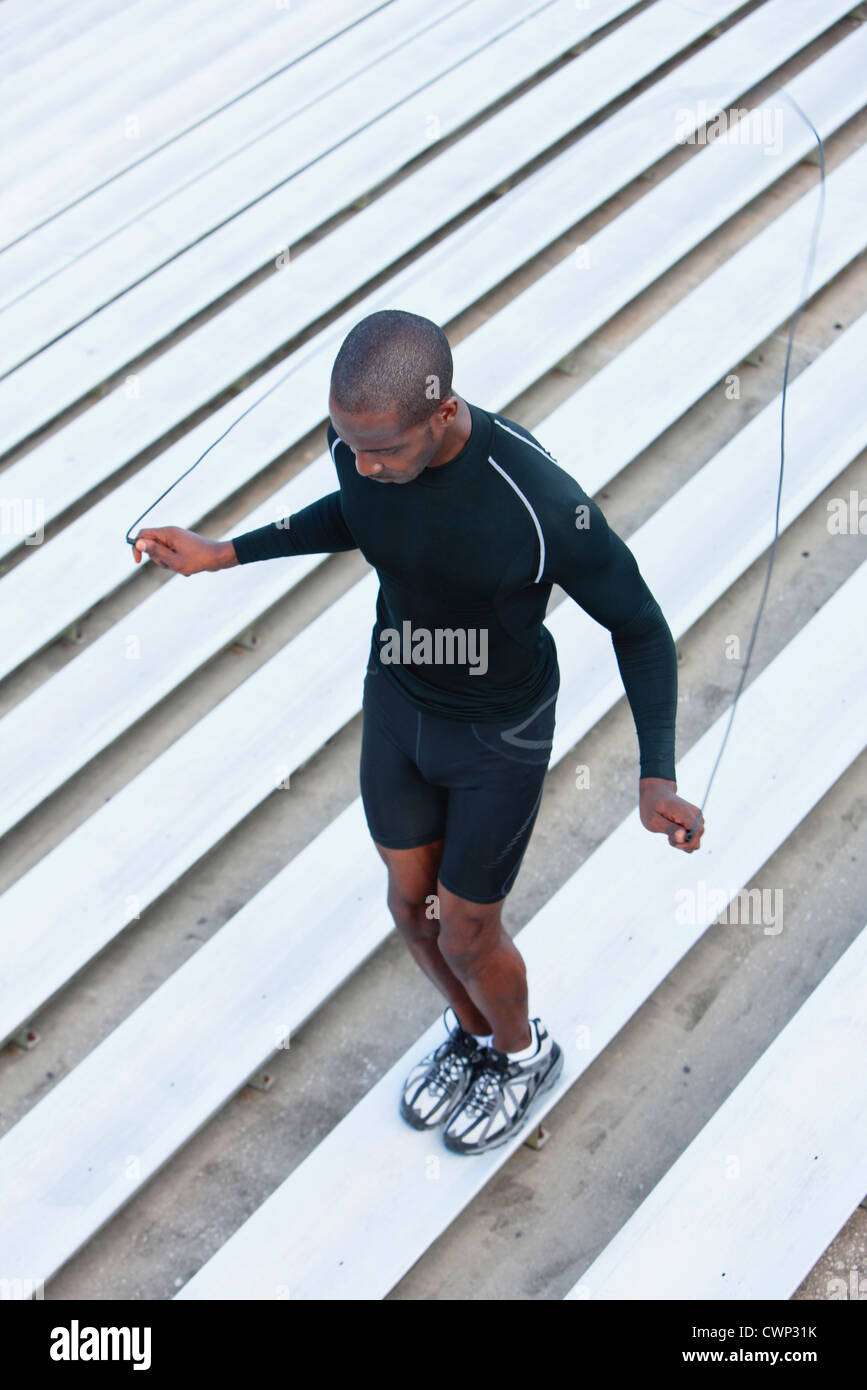 Man jumping rope on bleacher, high angle view Stock Photo - Alamy