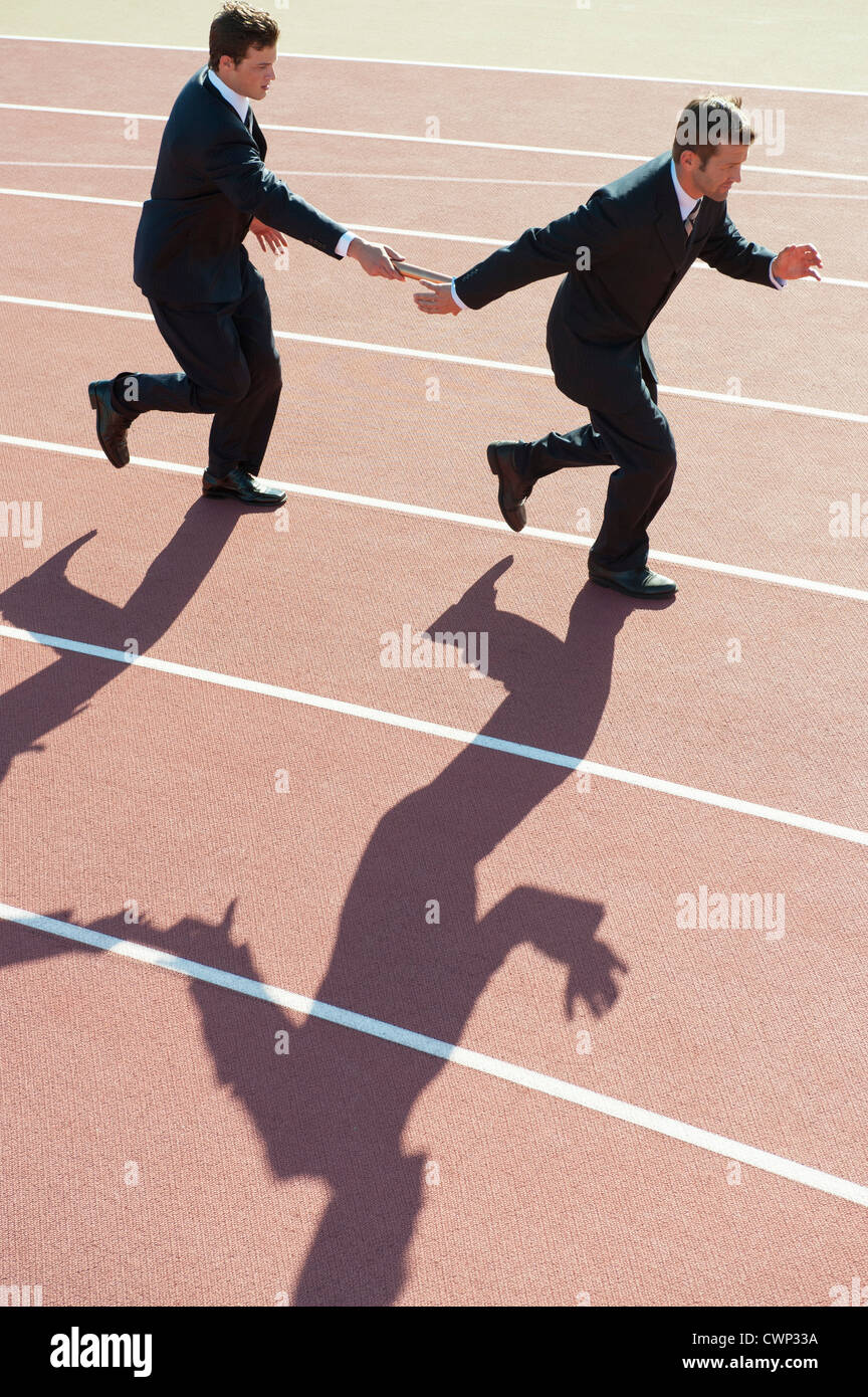 Businessmen running relay race Stock Photo - Alamy
