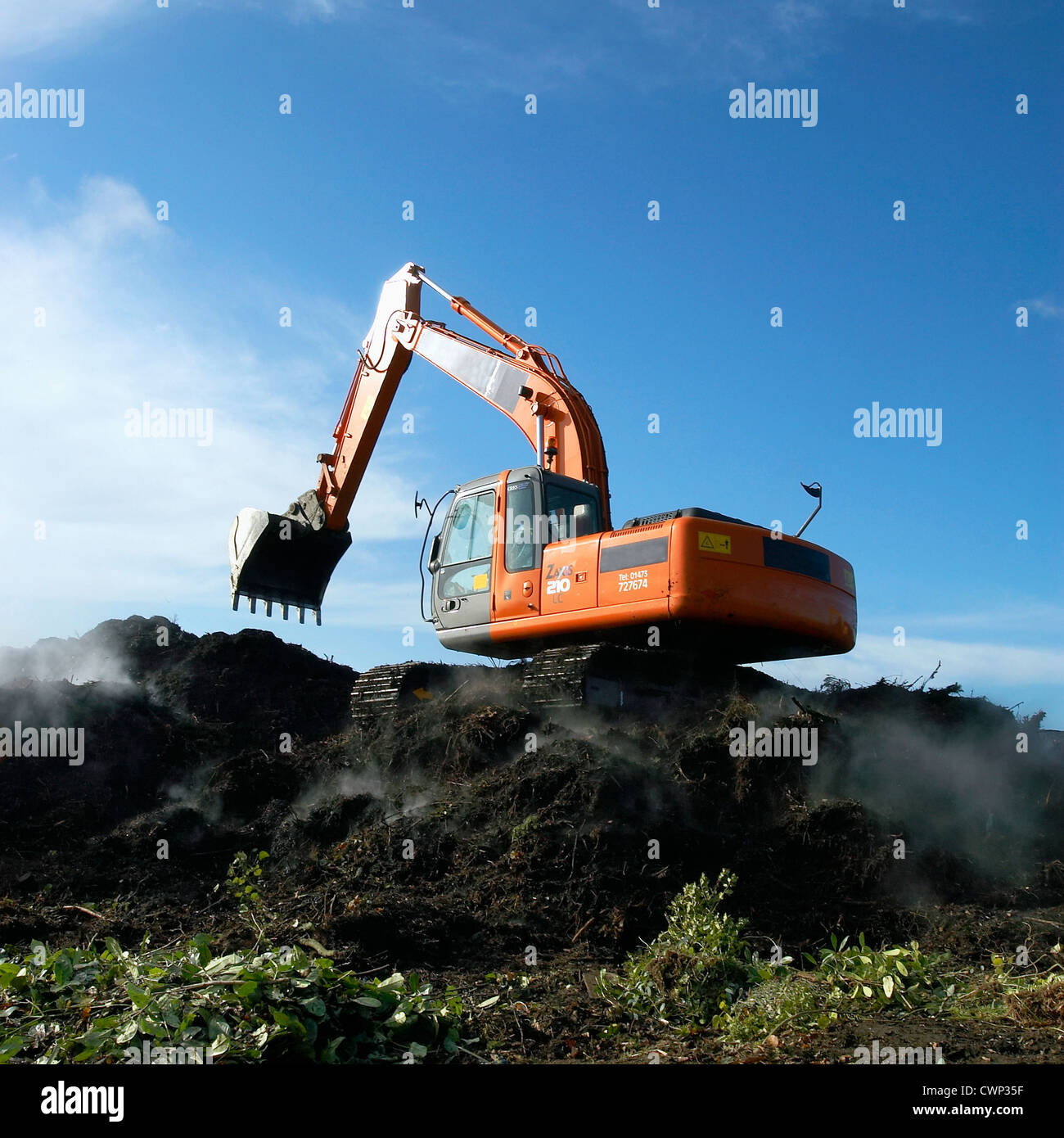 Tracked excavator on landfill Stock Photo - Alamy