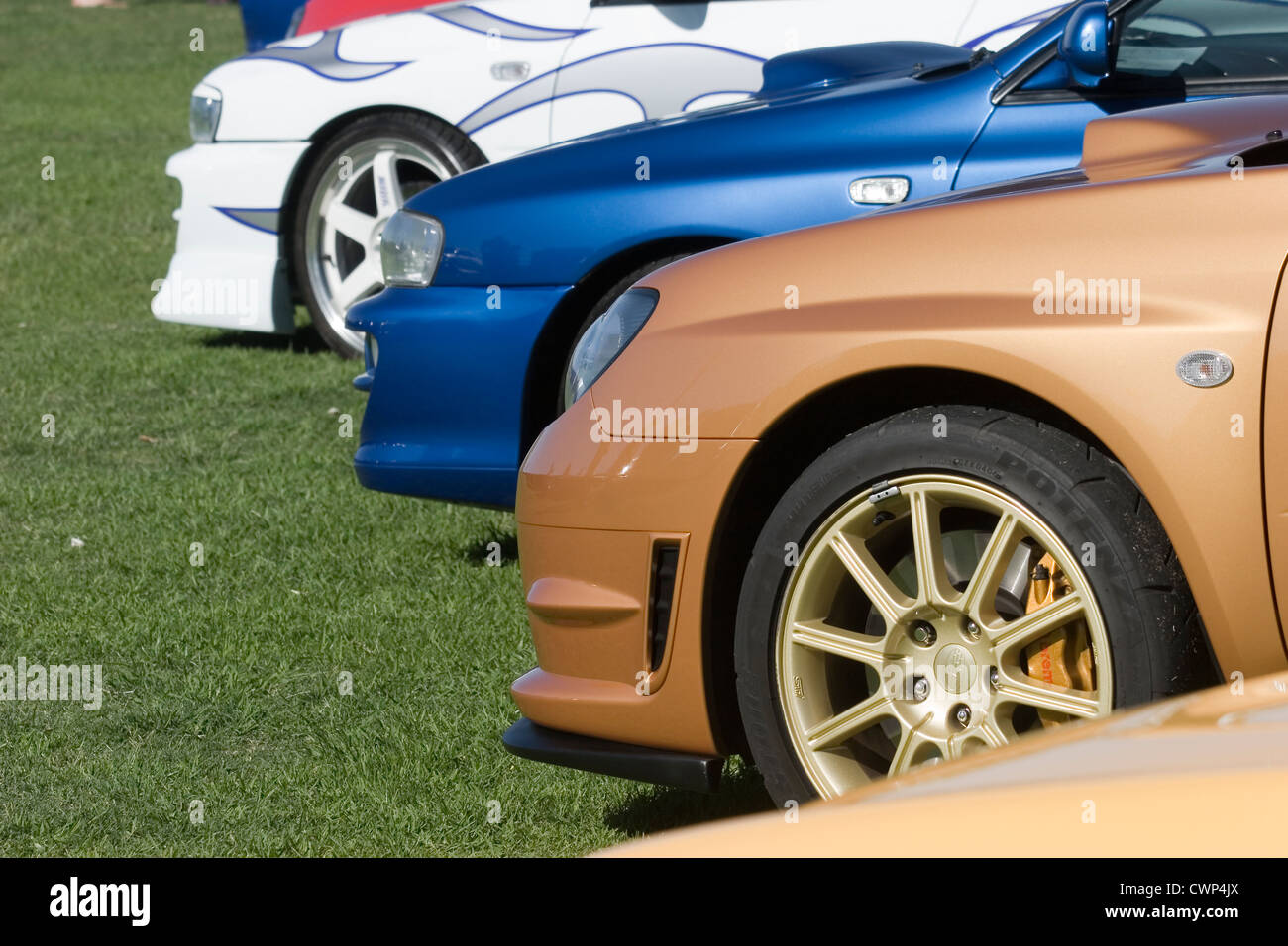 Front end including alloy wheels of Subaru WRX sports cars lined up at ...