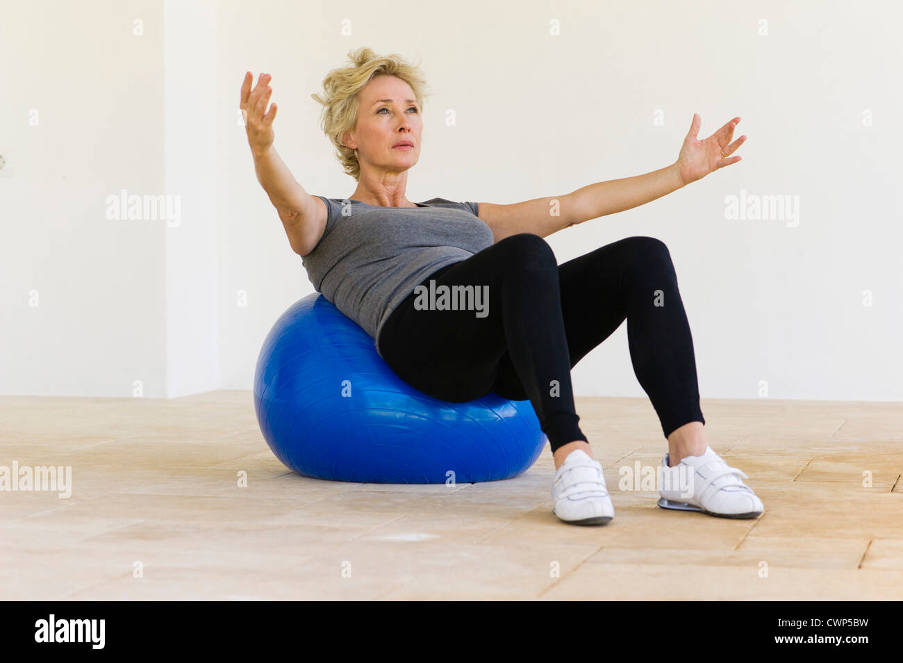 Mature woman doing pilates exercise on fitness ball Stock Photo - Alamy