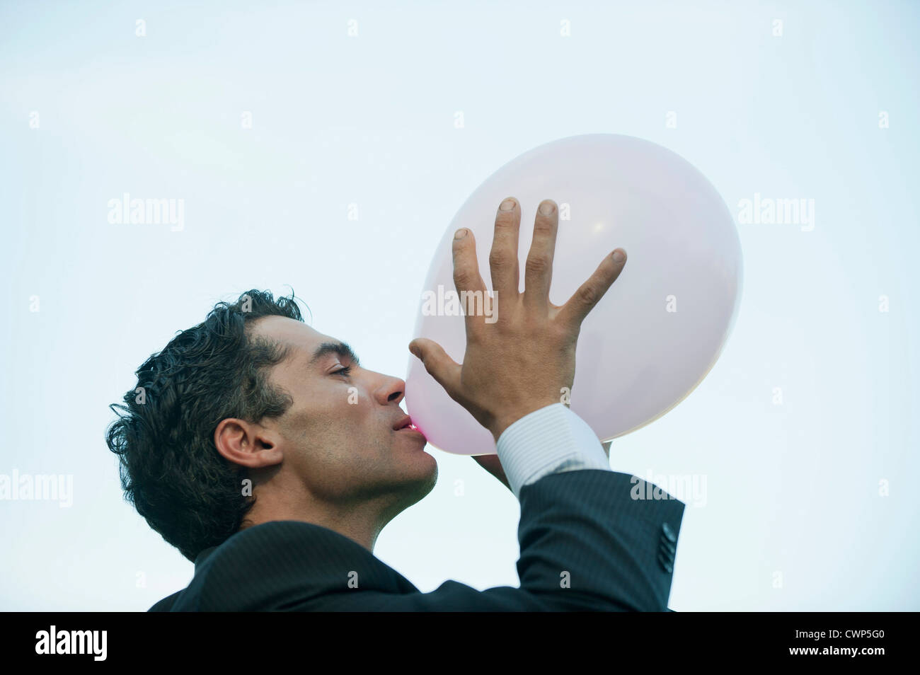 Man blowing up balloons hi-res stock photography and images - Alamy