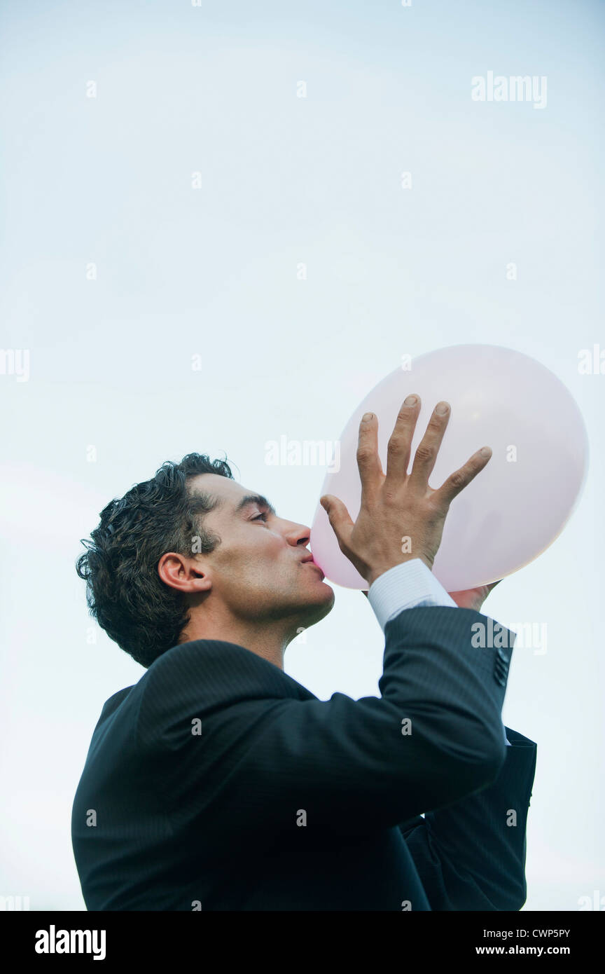 Man blowing up balloons hi-res stock photography and images - Alamy