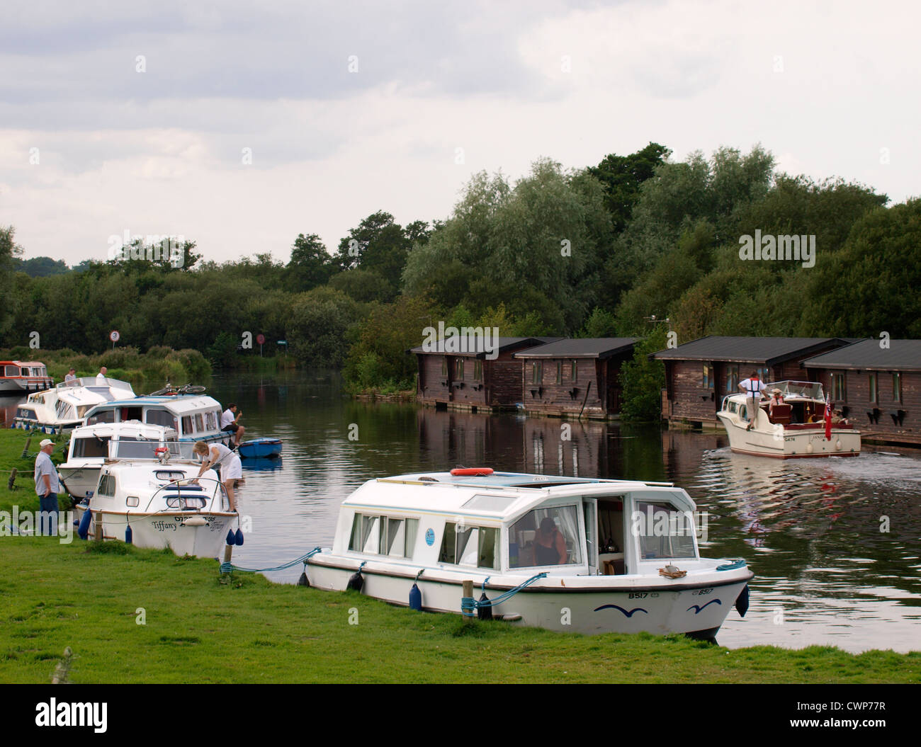 Boats and cabins on the River Ant at Wayford bridge, Norfolk Broads, UK ...