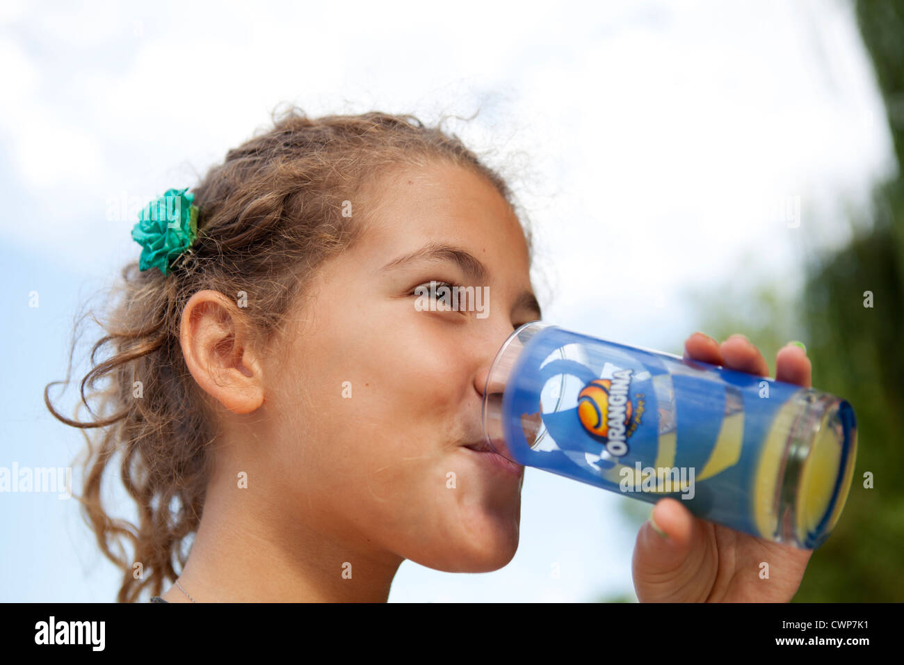 Young girl drinking French orange drink called Orangina Stock Photo - Alamy
