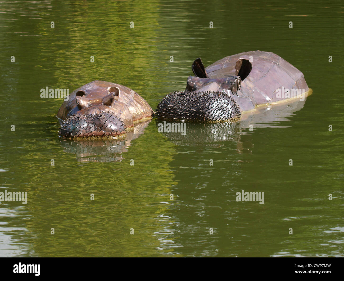 Metal hippopotamus pond sculptures, UK Stock Photo - Alamy