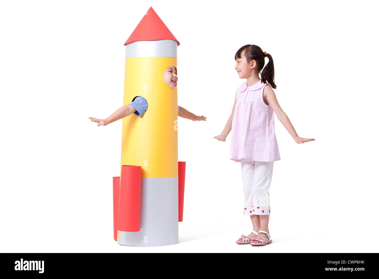 Boy and girl with a toy rocket Stock Photo - Alamy