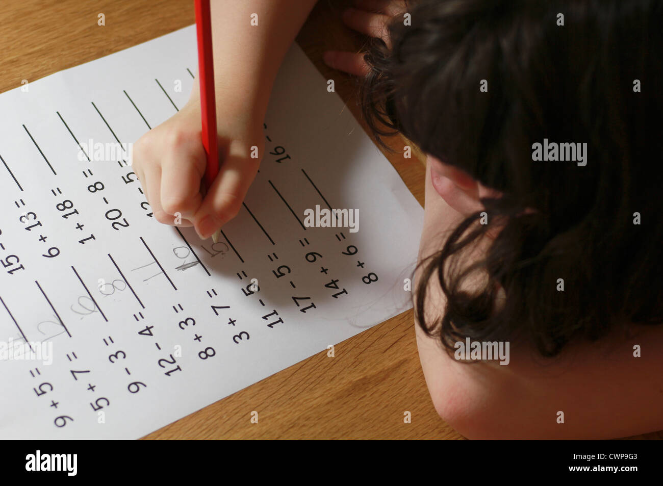 Little girl doing maths homework Stock Photo - Alamy