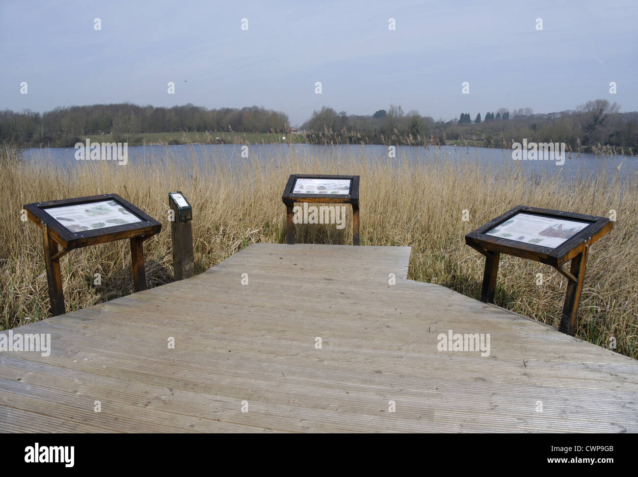 Boardwalk and information boards overlooking lake in flooded former ...